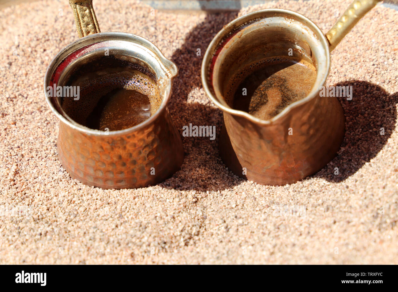 Preparation of traditional turkish coffee in cezve on hot sand Stock ...