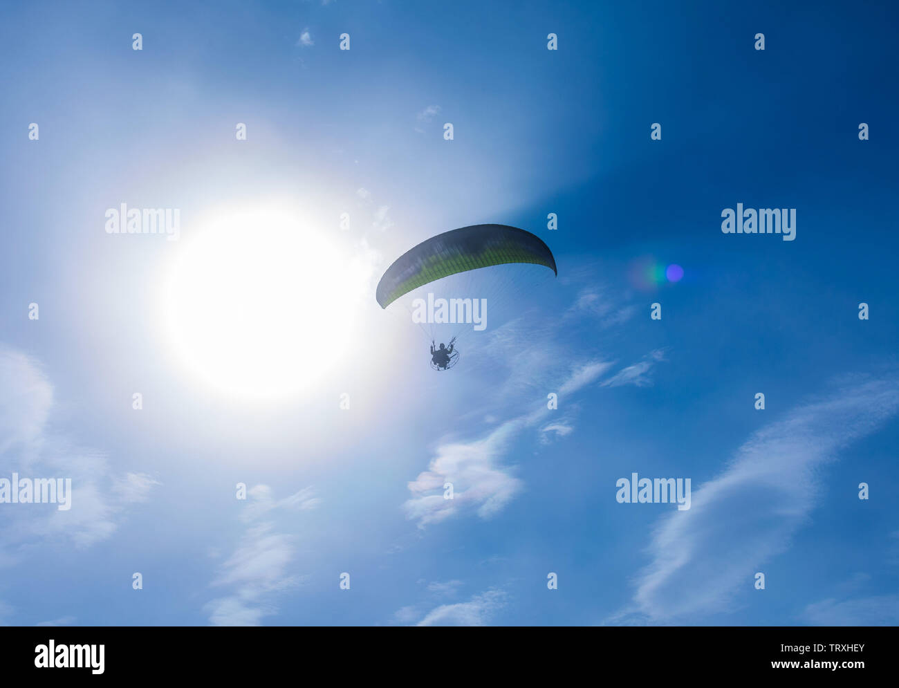 Parachutist flies against the blue sky. Motorized parachute Stock Photo ...