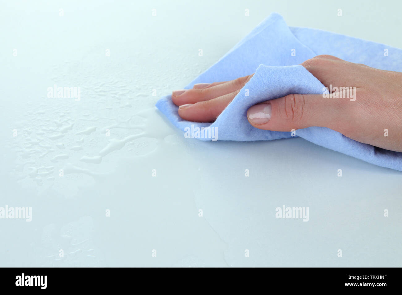 Hand wiping surface with blue rag isolated on white Stock Photo - Alamy