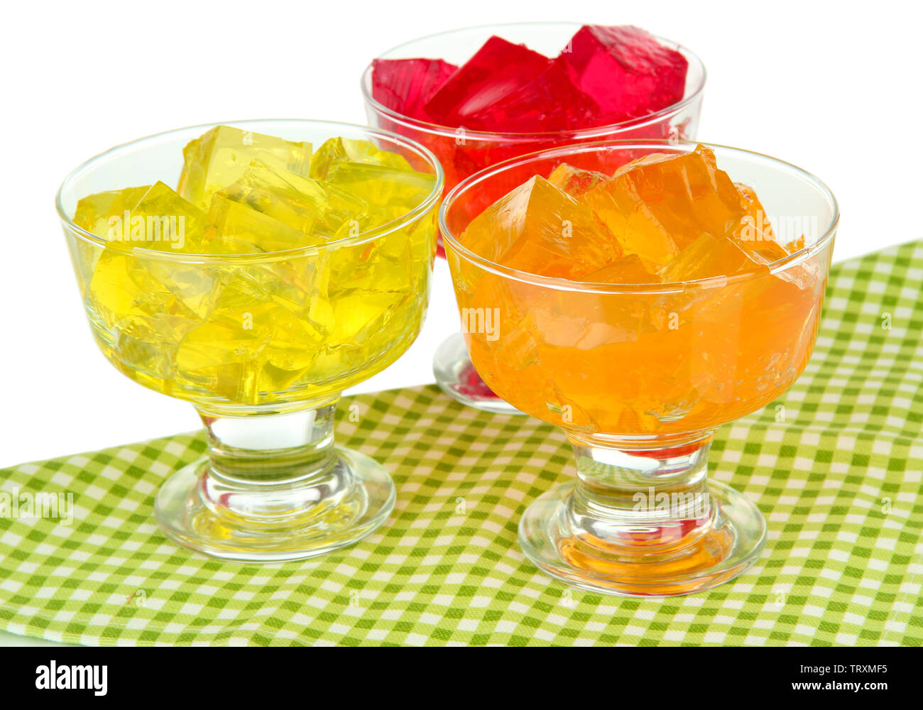 Tasty jelly cubes in bowls on table on white background Stock Photo - Alamy