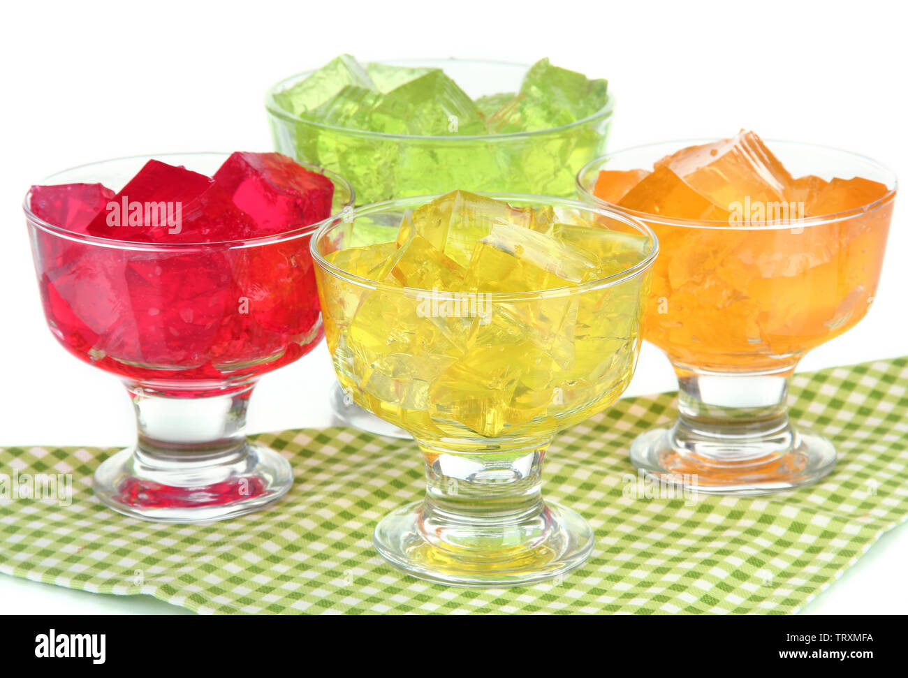Tasty jelly cubes in bowls on table on white background Stock Photo - Alamy