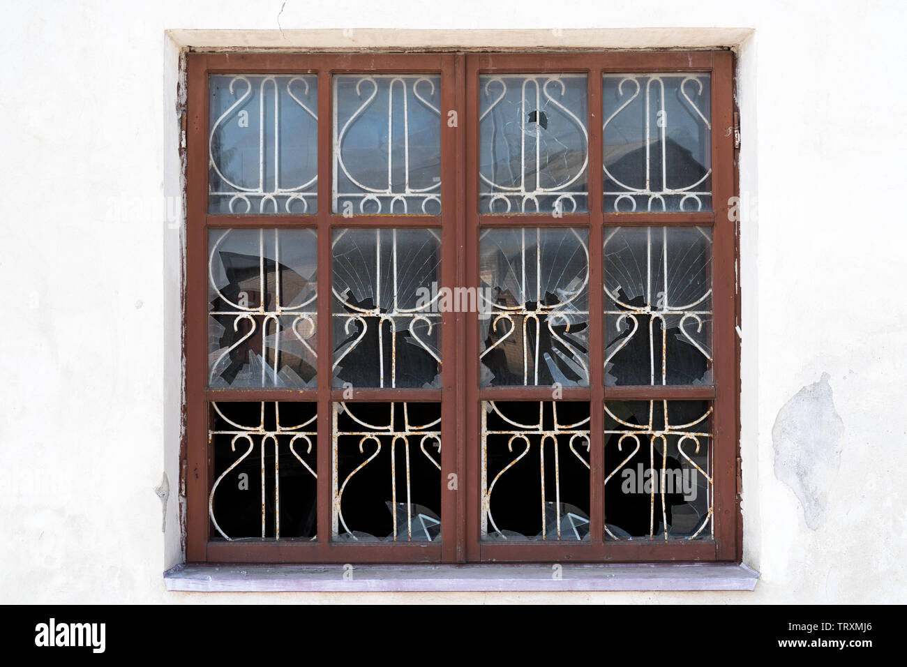 Broken barred window in an abandoned house. Vandalism,hooliganism ...