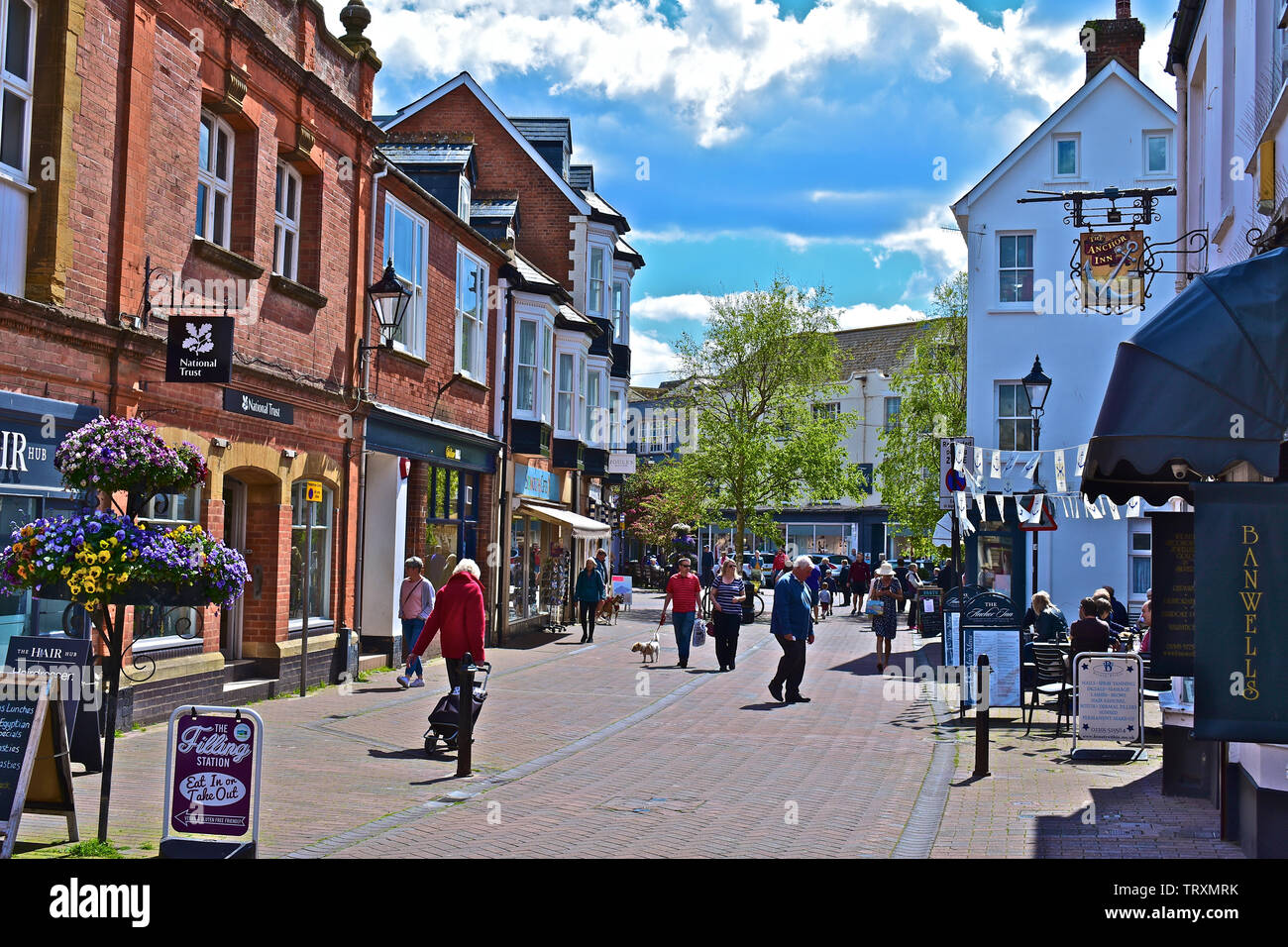 Shoppers enjoying the mix of small shops & traditional pubs in quaint ...