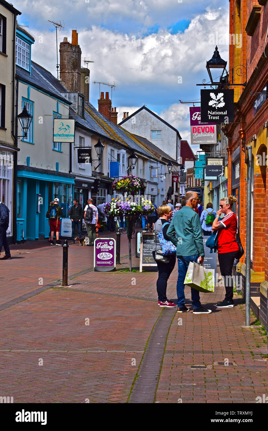 Shoppers enjoying the mix of small shops & traditional pubs in quaint ...
