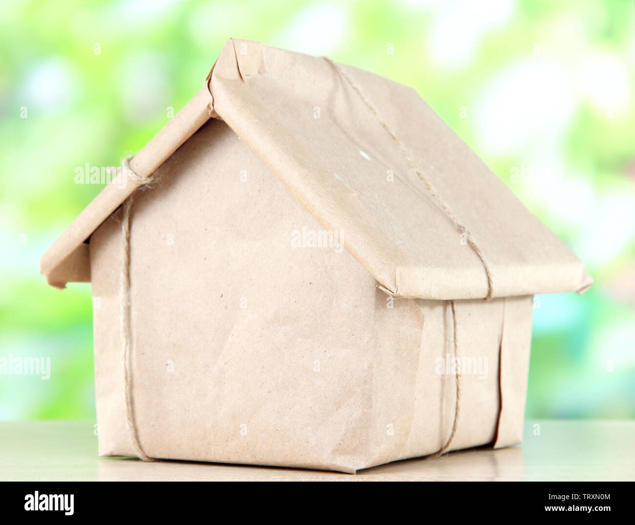 House wrapped in brown kraft paper, on nature background Stock Photo ...