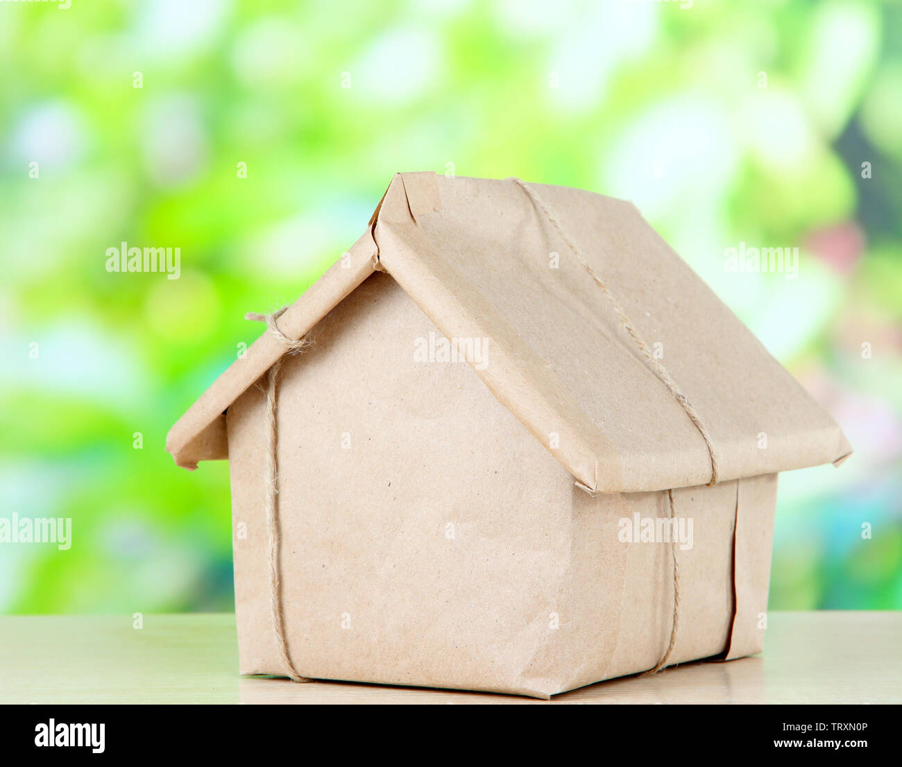 House wrapped in brown kraft paper, on nature background Stock Photo ...