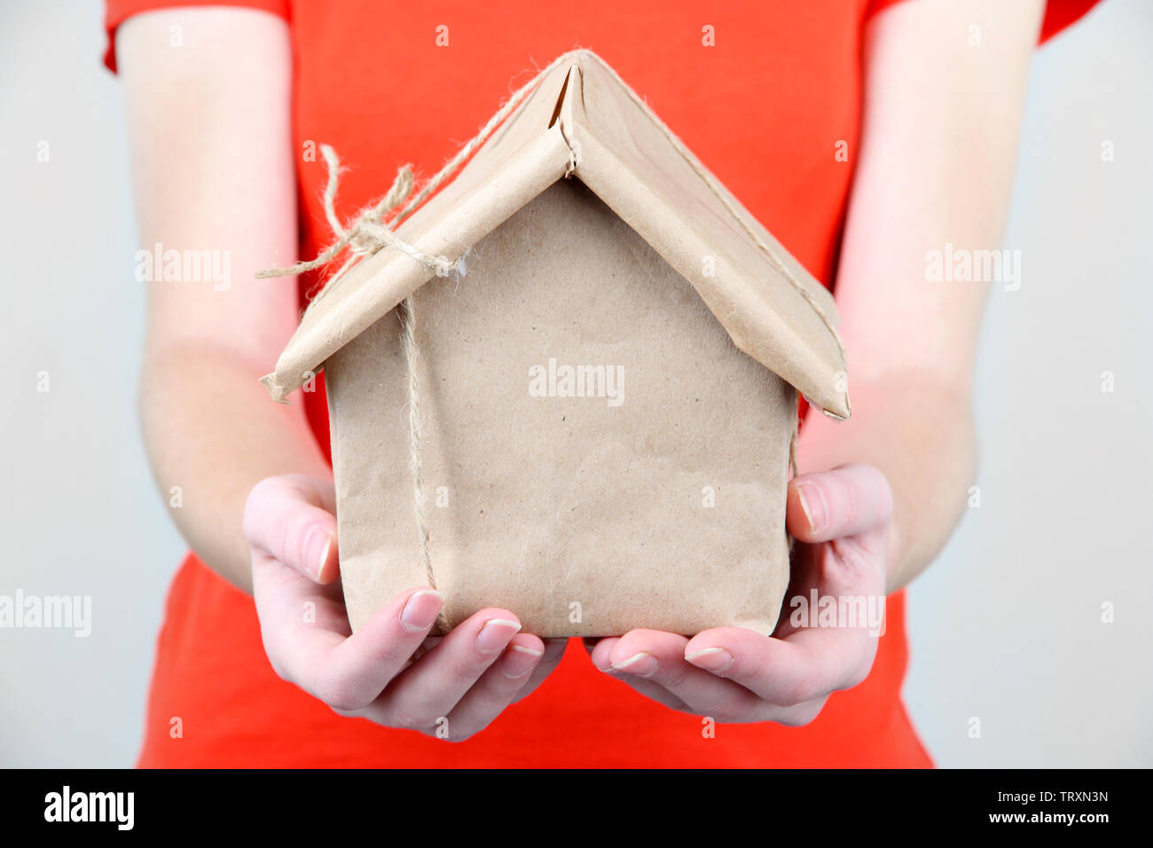 Woman hands holding a house wrapped in brown kraft paper Stock Photo ...