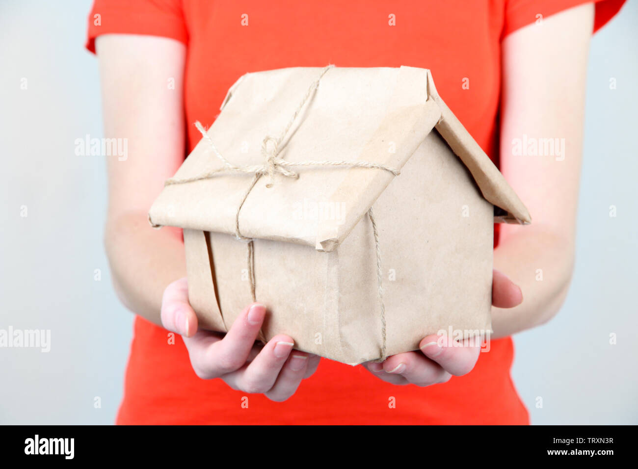 Woman hands holding a house wrapped in brown kraft paper Stock Photo ...
