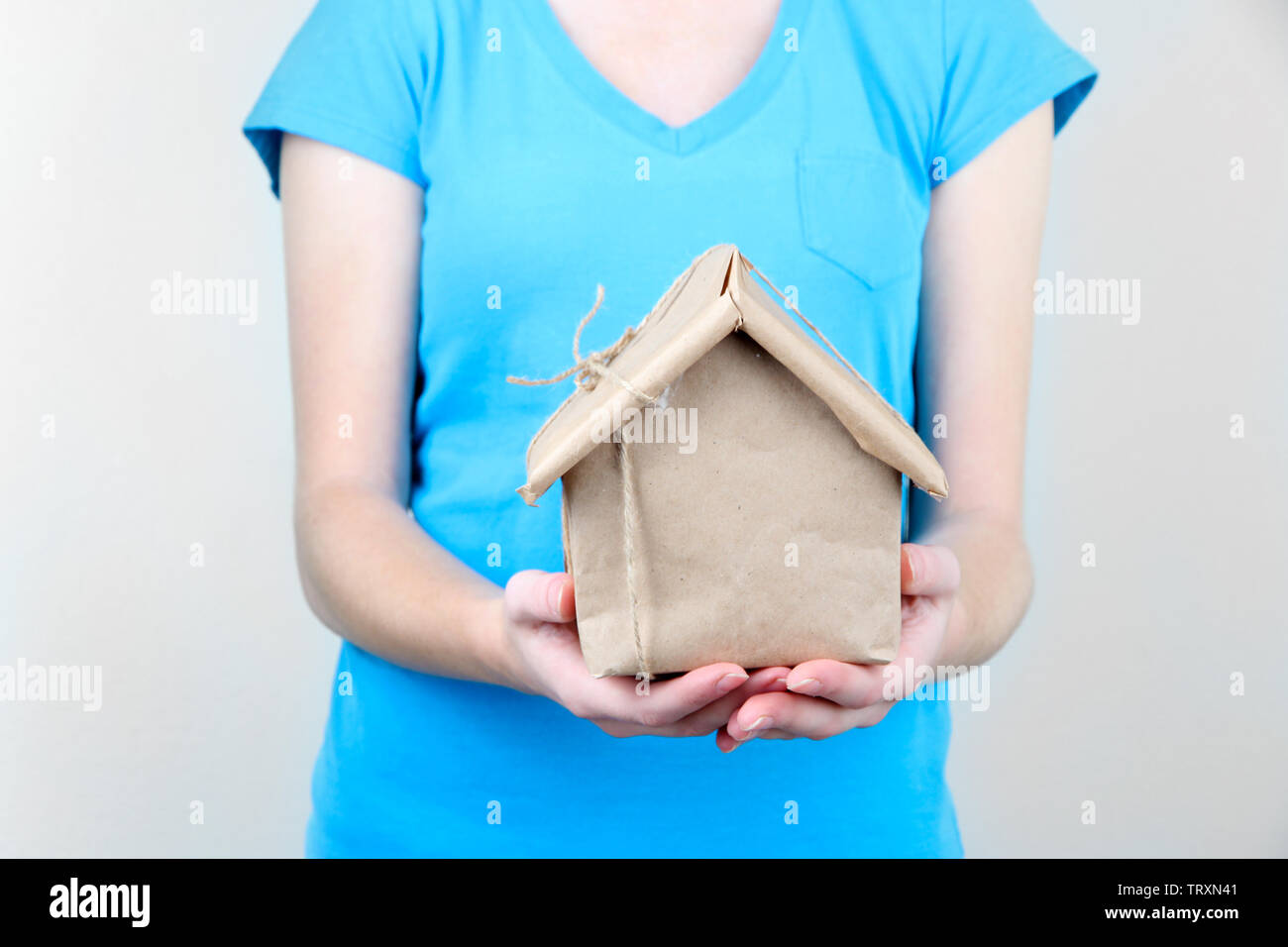 Woman hands holding a house wrapped in brown kraft paper Stock Photo ...