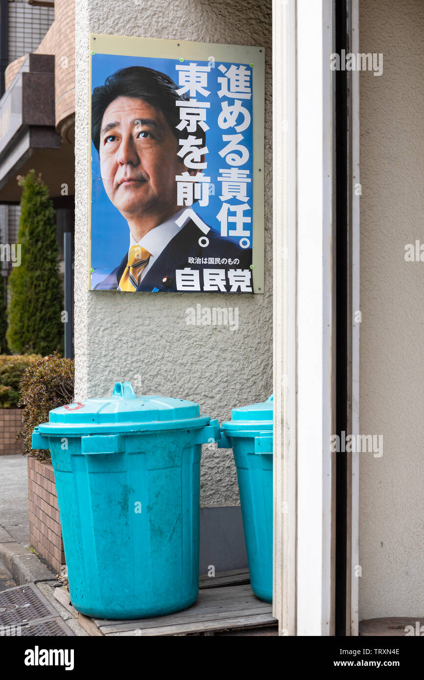 Shinzo Abe poster above two rubbish bins; Shinjuku, Tokyo, Japan Stock ...
