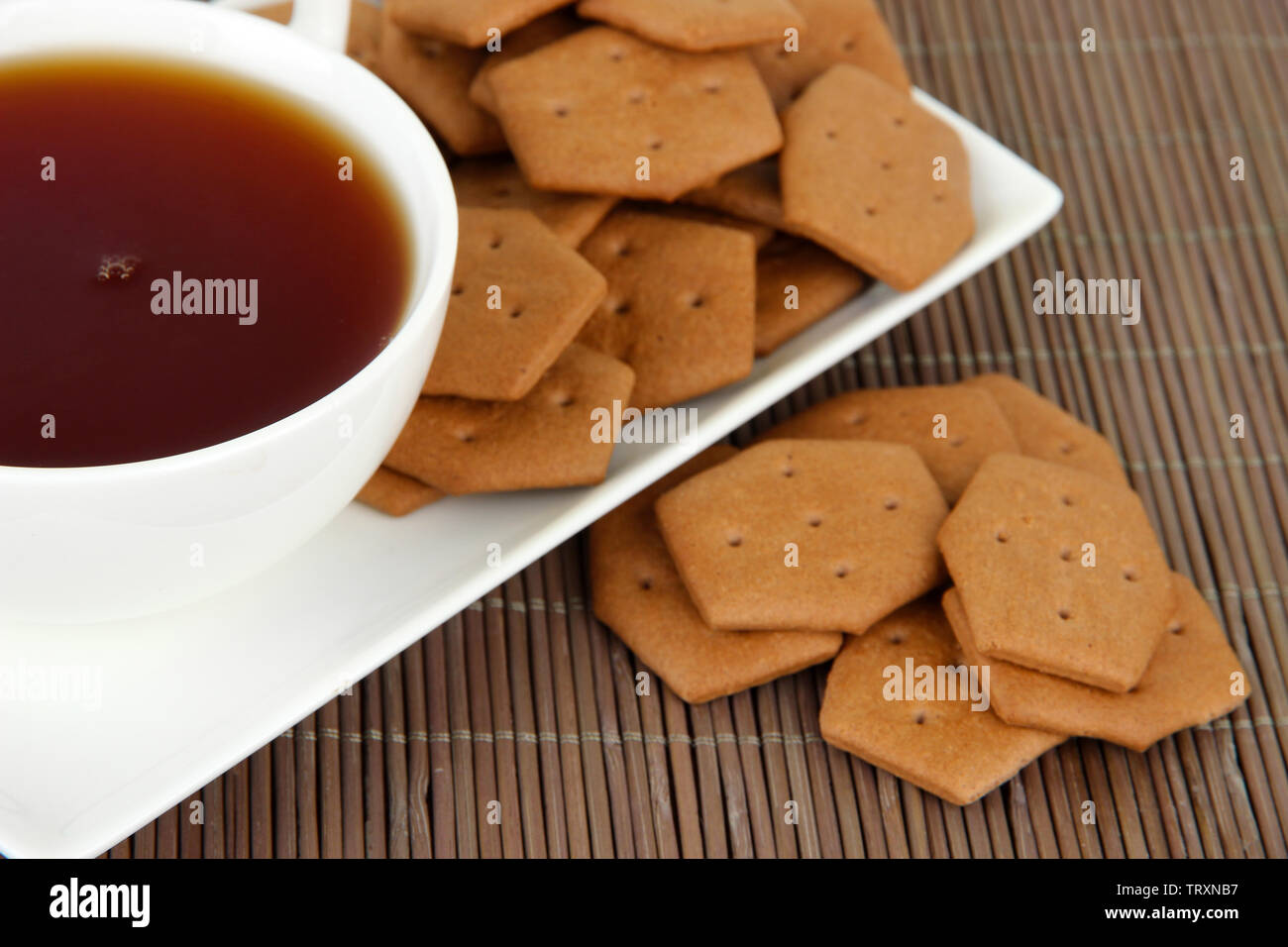 Chocolate crackers with cup of tea on bamboo background Stock Photo - Alamy