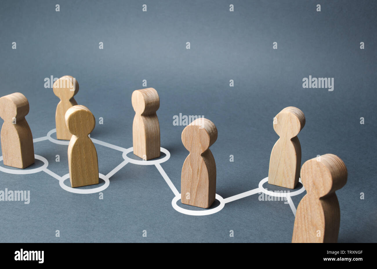 Chain of people figurines connected by white lines. Cooperation and ...