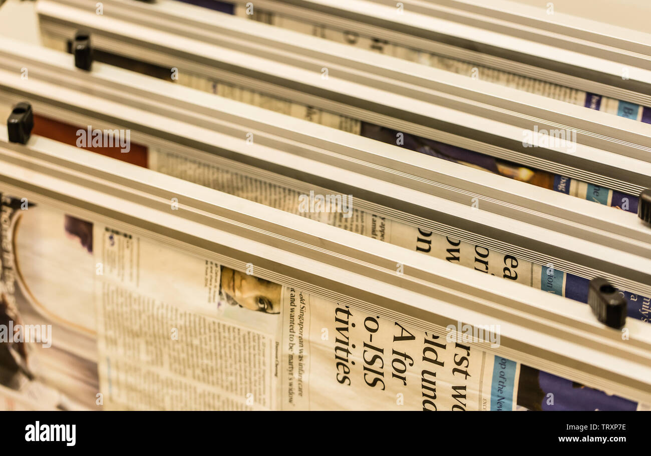 Singapore-JUL 30 2017:newspaper hang on shelf for reader background ...