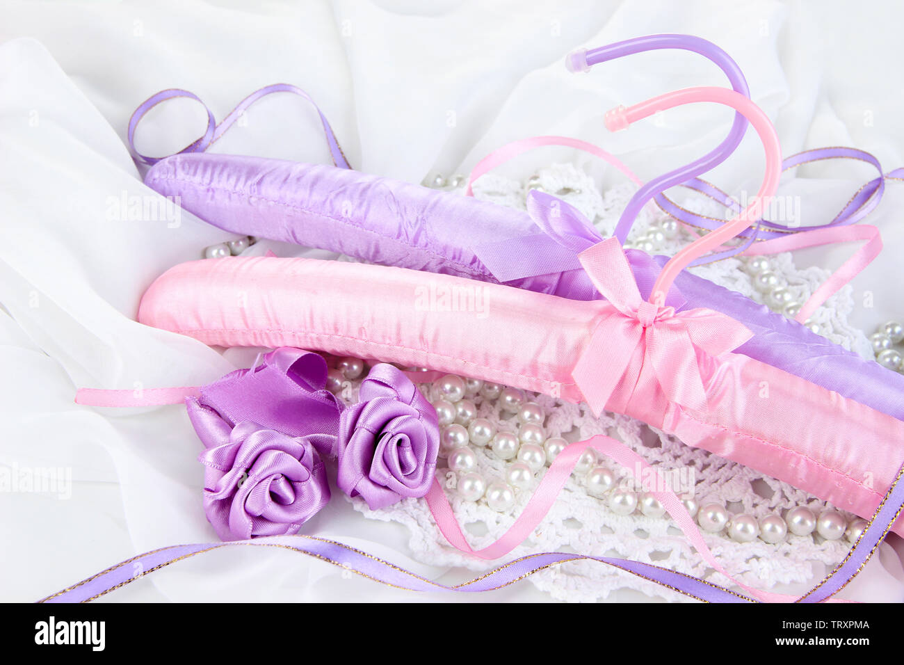 Beautiful hanger on fabric background Stock Photo - Alamy