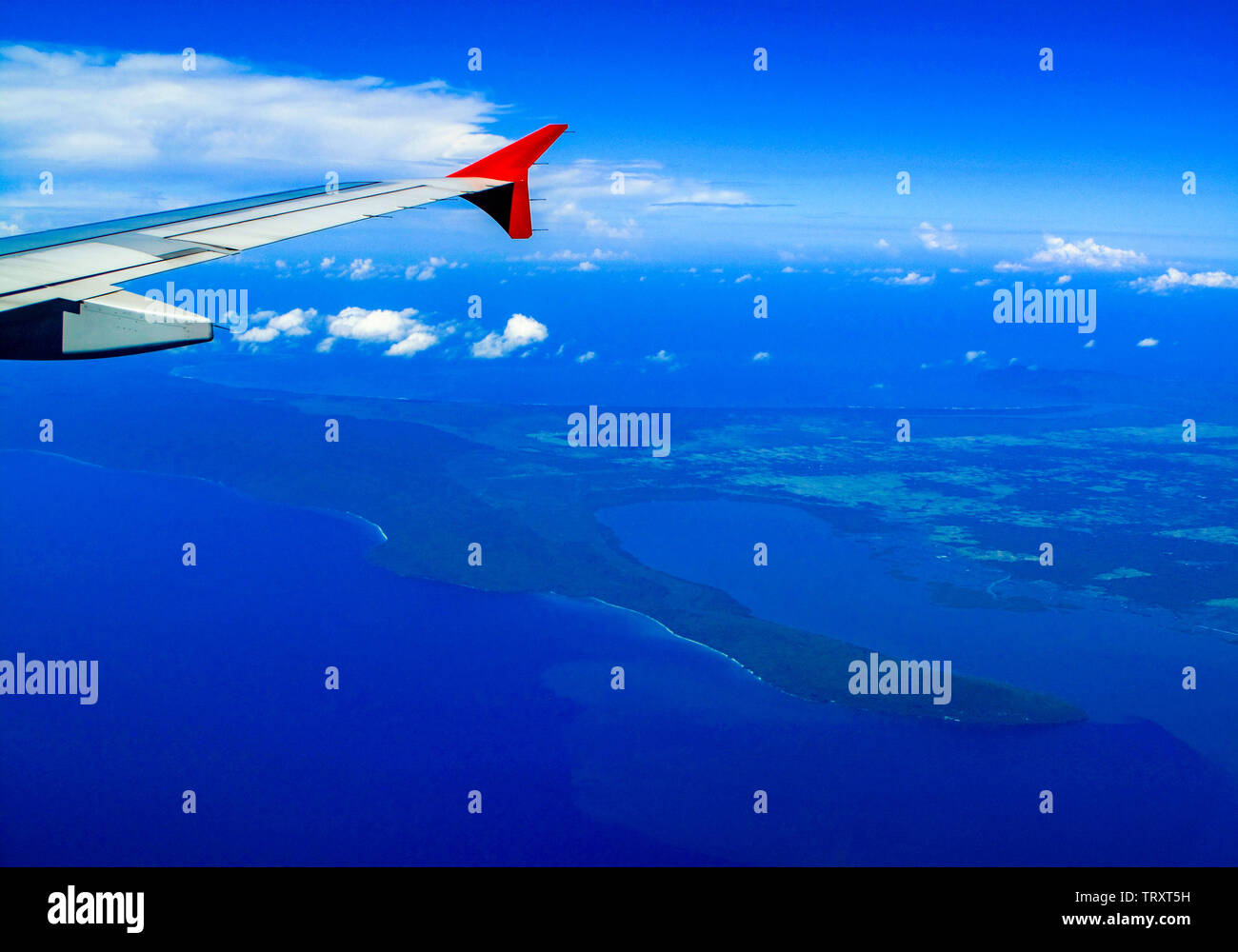 Aerial view from airplane. Bird eye view of land and blue ocean on a ...