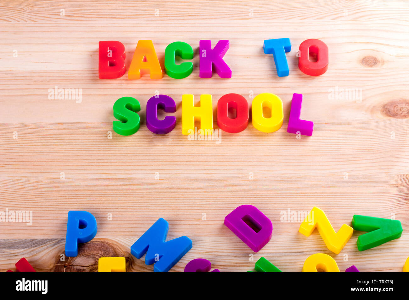 Back to school text written with magnetic coloured letters over a ...
