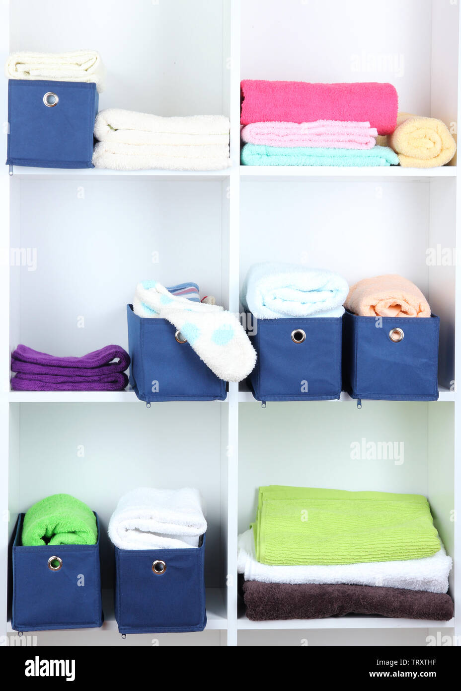 Blue textile boxes in white shelves Stock Photo - Alamy