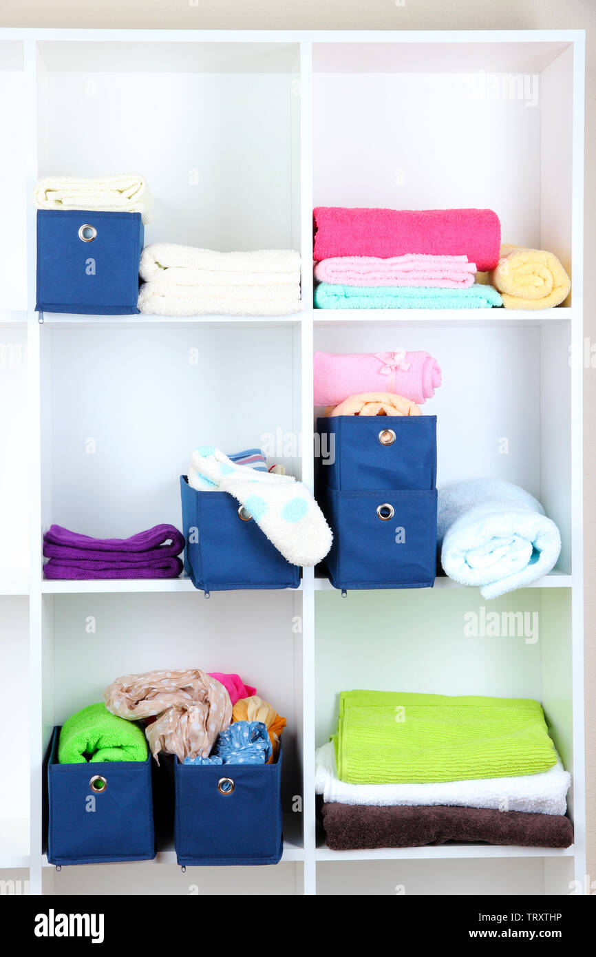Blue textile boxes in white shelves Stock Photo - Alamy