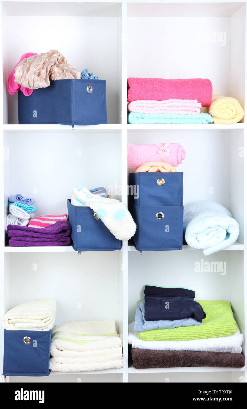 Blue textile boxes in white shelves Stock Photo - Alamy
