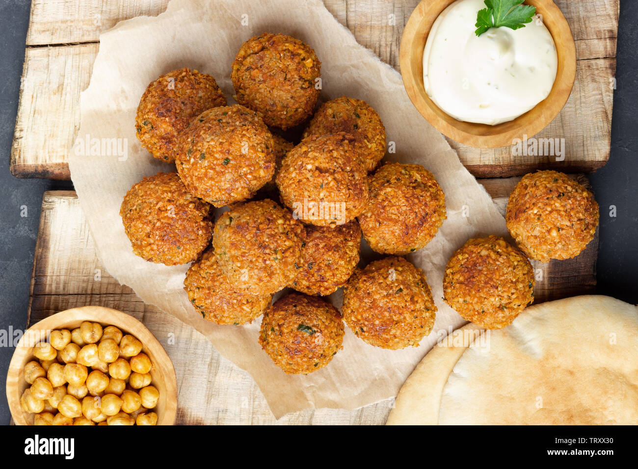 Vegetarian chickpeas falafel balls on wooden rustic board. Traditional ...