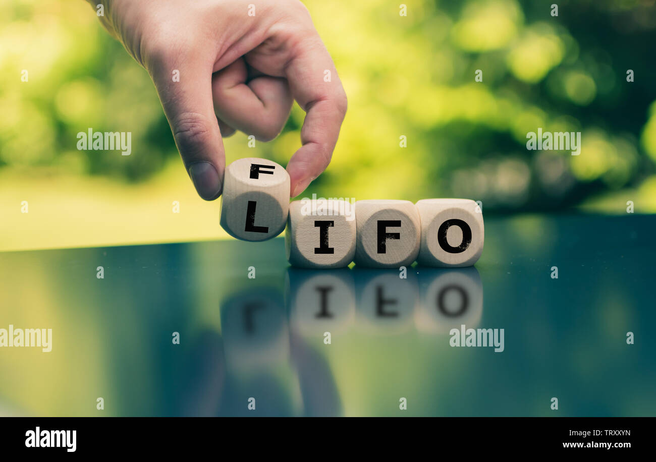 Hand turns a cube and changes the expression "FIFO" (first in, first ...