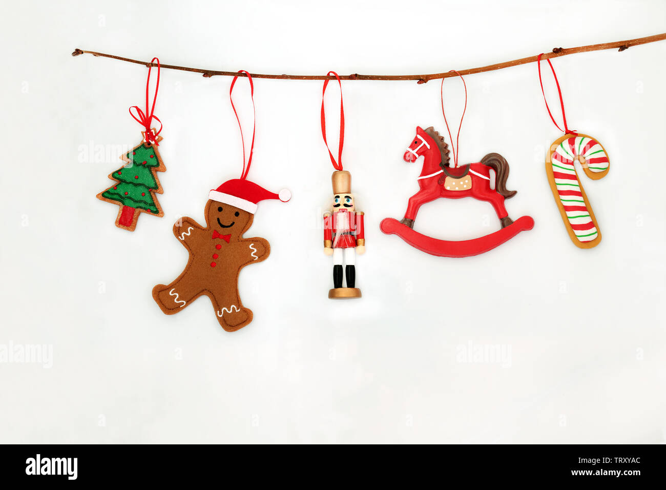 Christmas decorations hanging on a branch with nutcracker soldier, tree ...