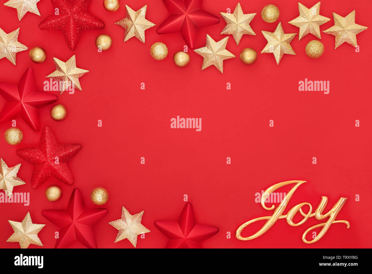 Christmas gold joy sign with star and bauble decorations on red ...