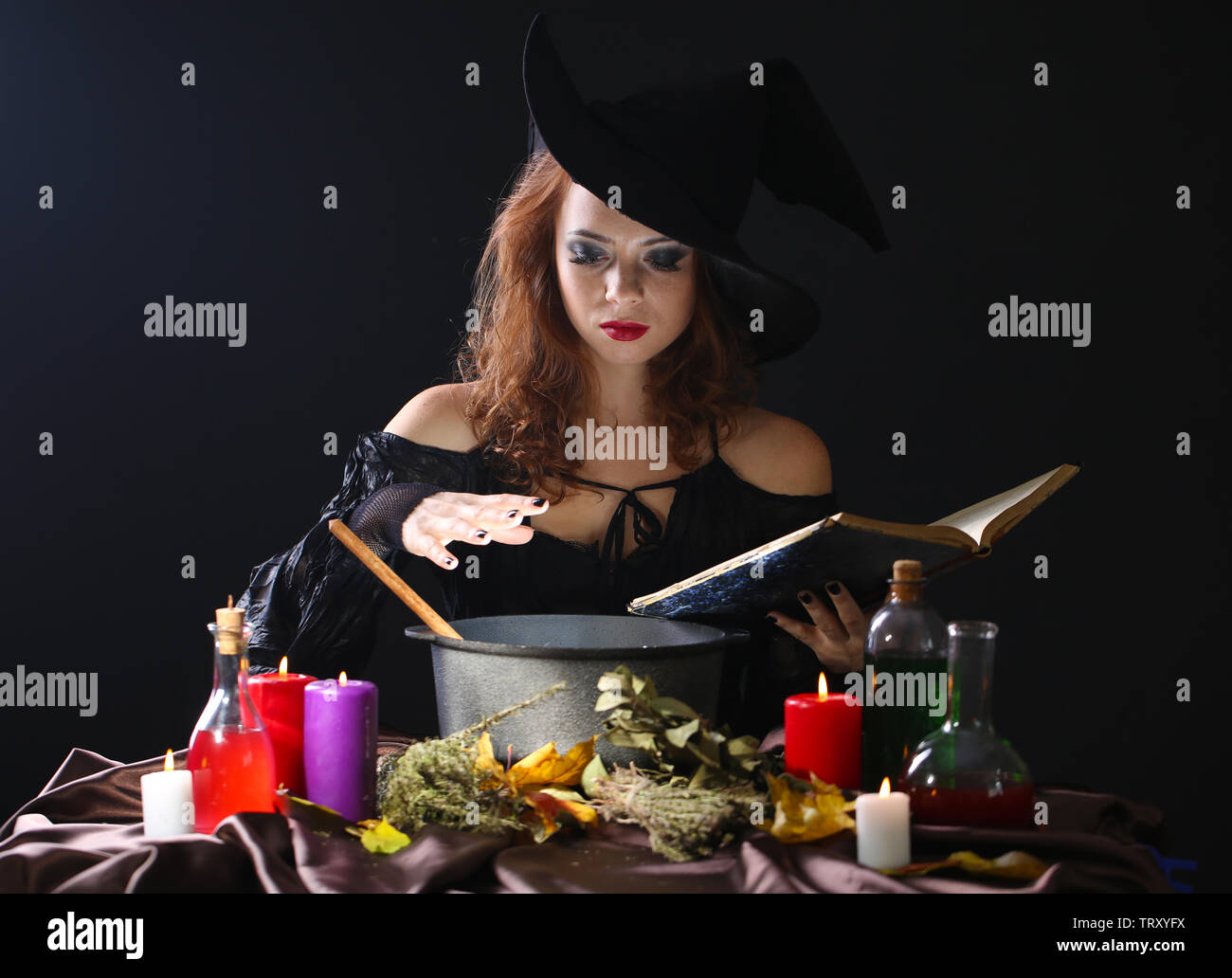 Halloween witch on black background Stock Photo - Alamy