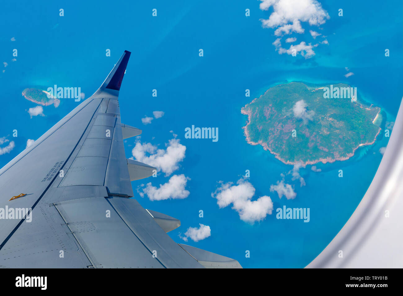 Airplane over Indonesian islands. Island view through aircraft window ...