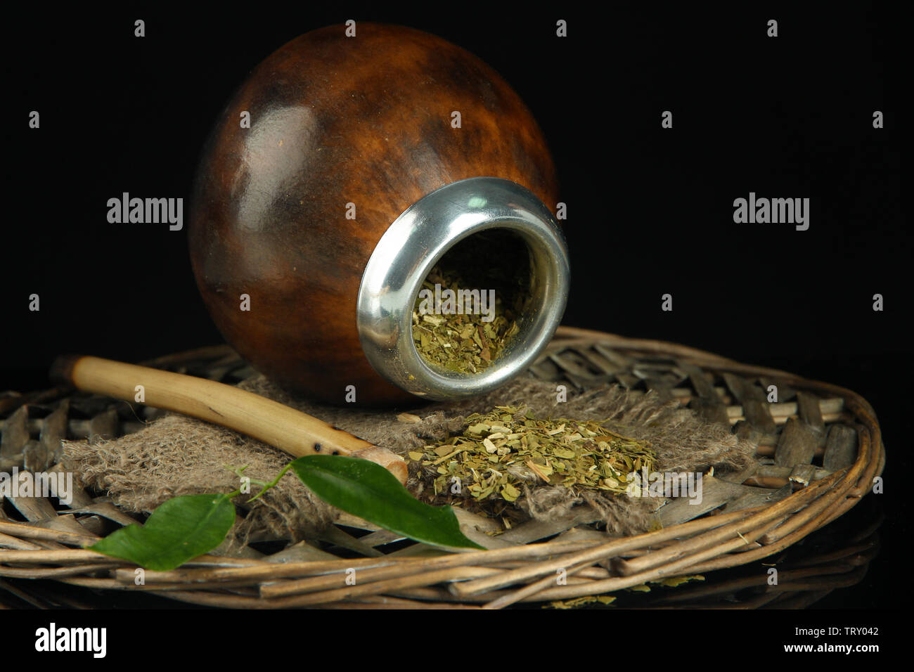 Calabash and bombilla with yerba mate isolated on black Stock Photo - Alamy