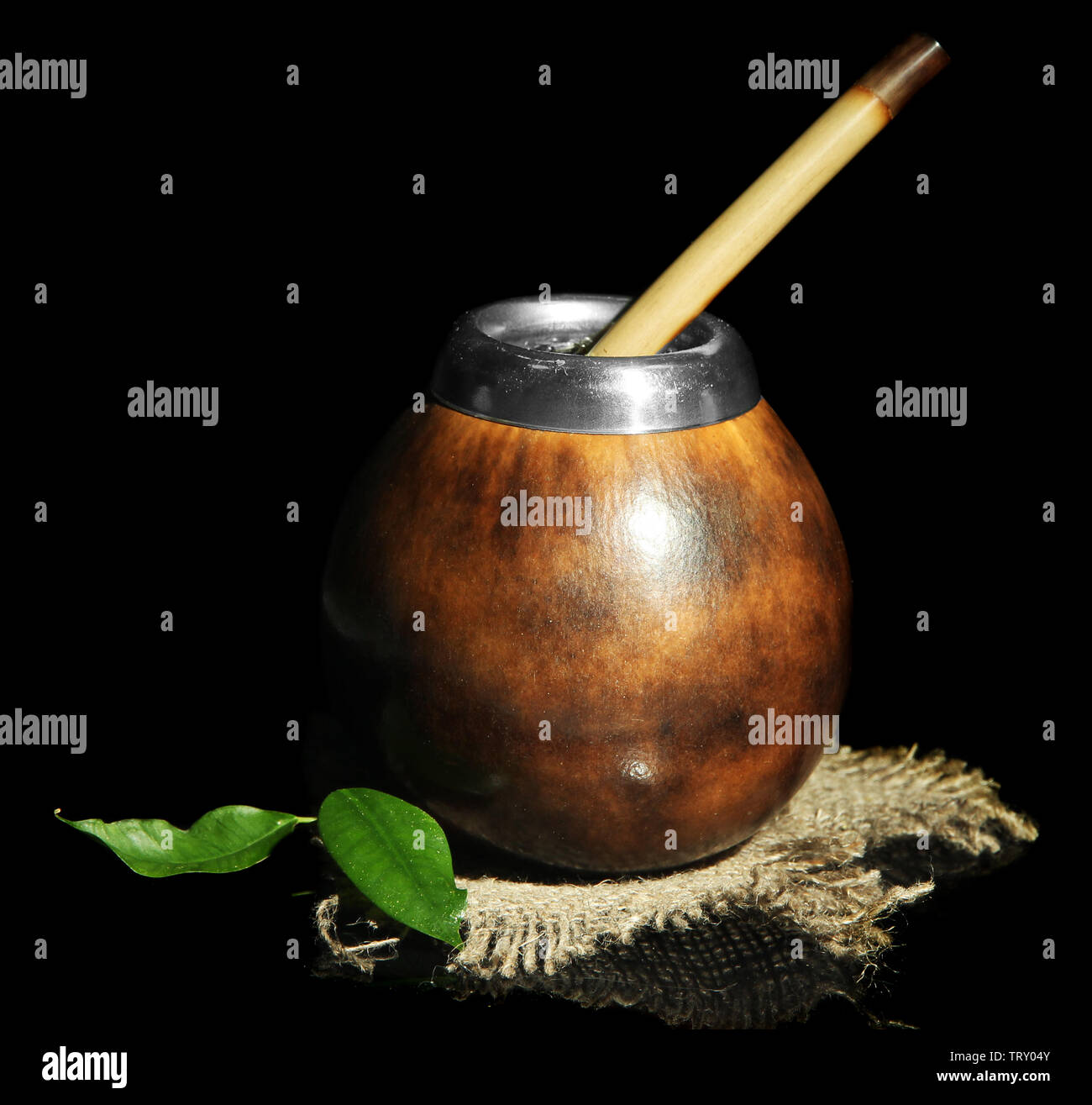 Calabash and bombilla with yerba mate isolated on black Stock Photo - Alamy