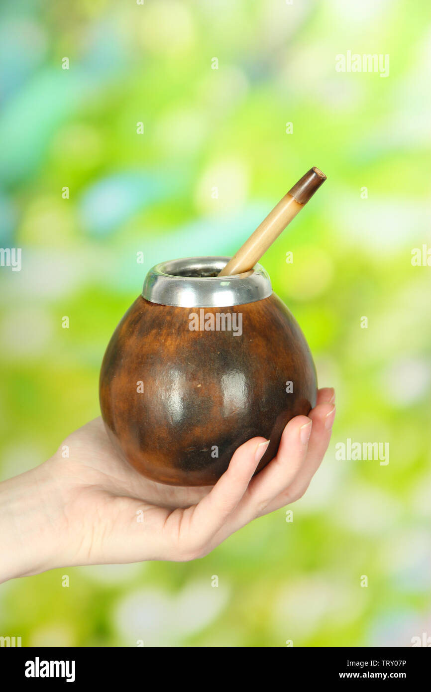 Woman hand giving calabash and bombilla with yerba mate, on nature ...