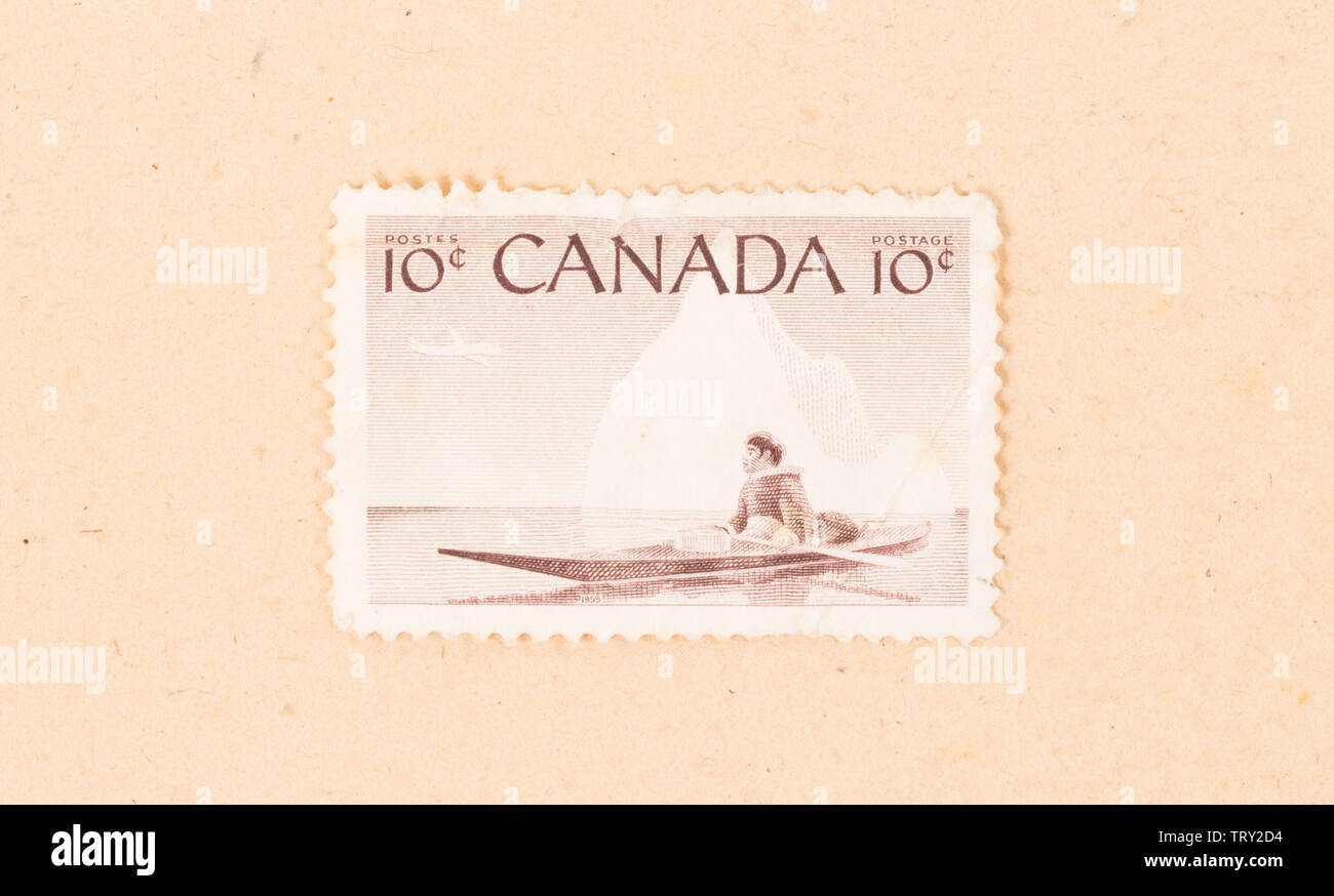 CANADA - CIRCA 1970: A stamp printed in Canada shows a native in a ...