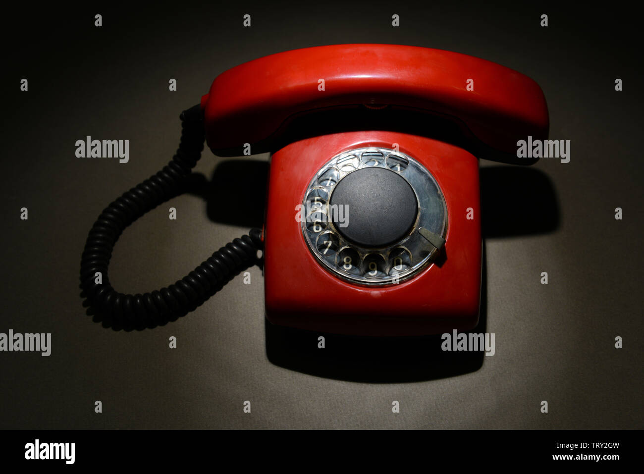 Red retro telephone on dark color background Stock Photo - Alamy
