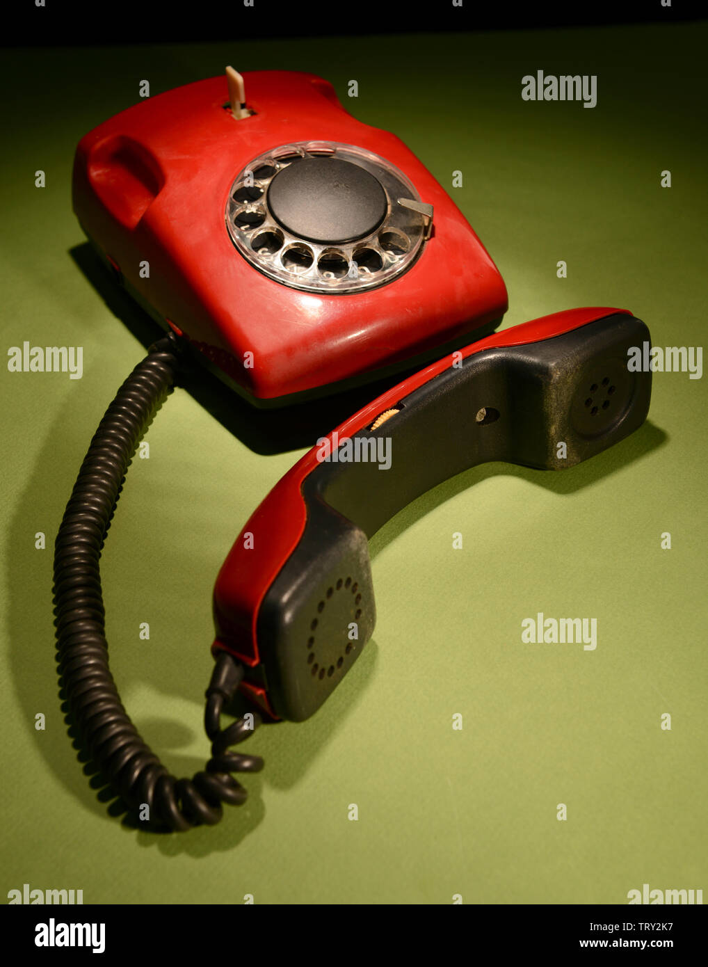 Red retro telephone on dark color background Stock Photo - Alamy