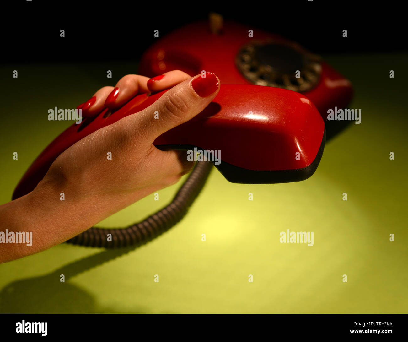 Red retro telephone on dark color background Stock Photo - Alamy