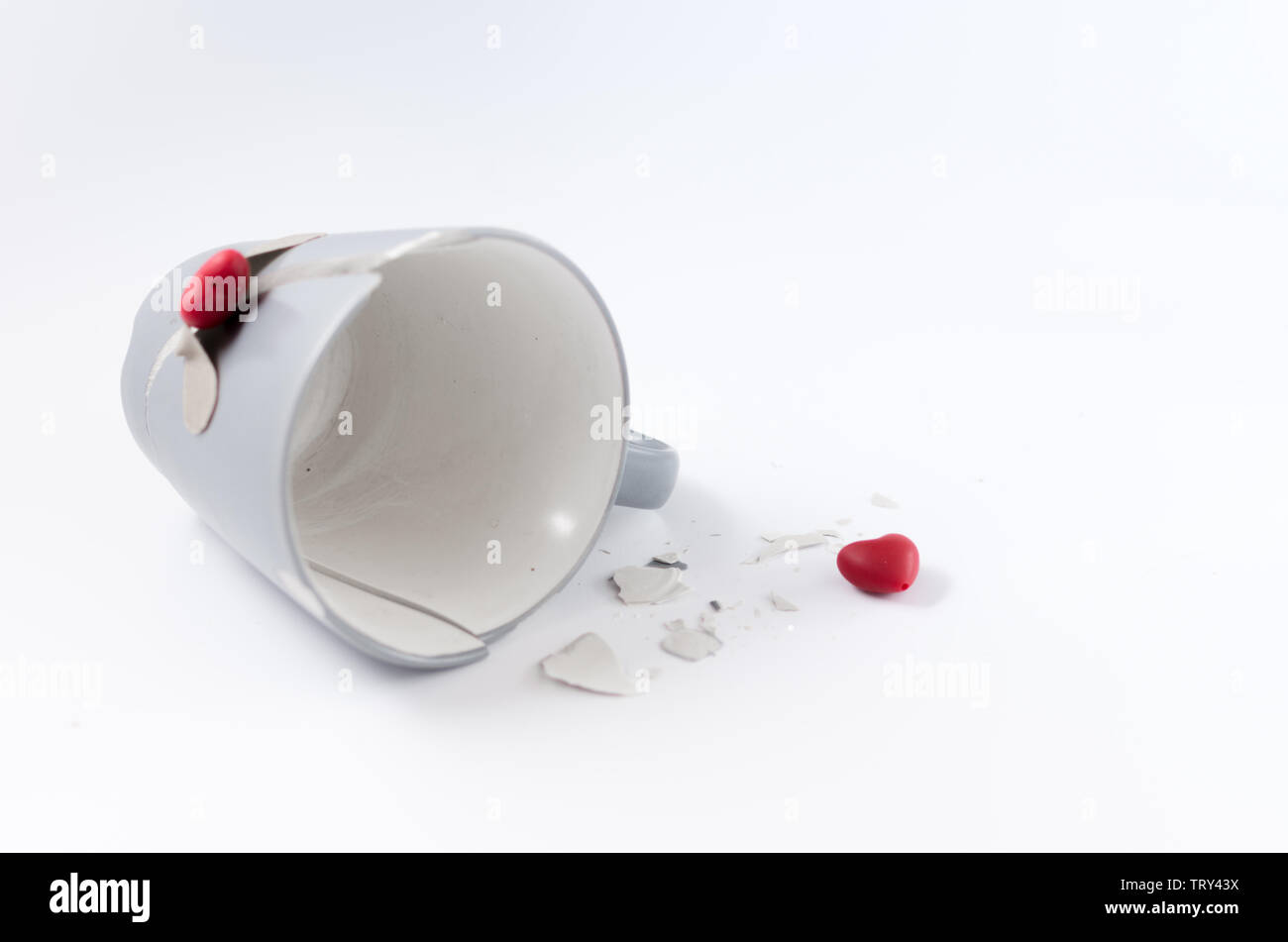 Inverted broken mug. A crack in the mug. Heart and love. White ...