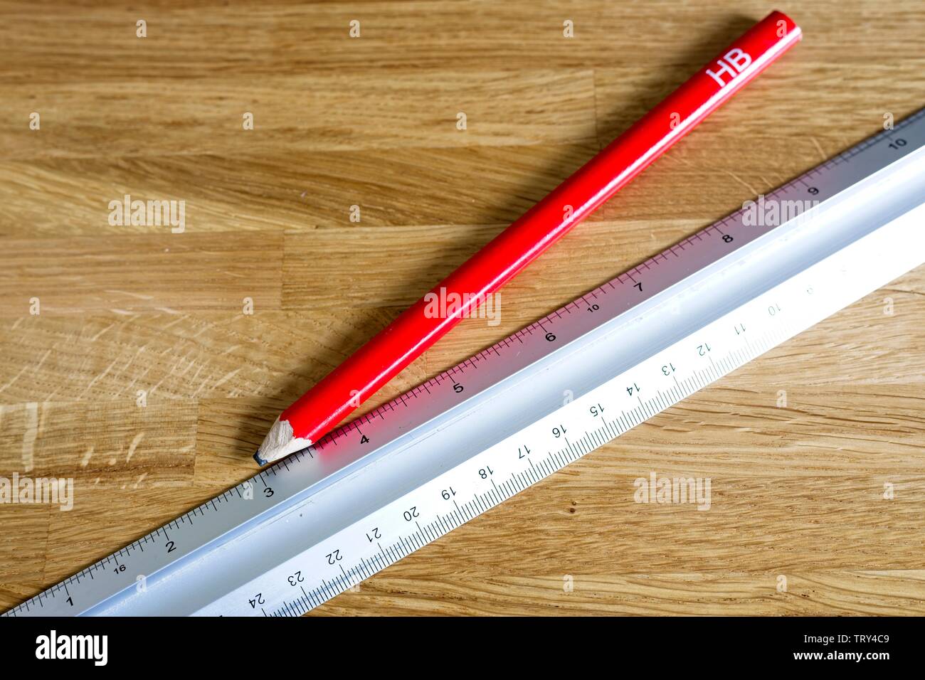 Pencil and metal ruler used for measuring and marking straight lines ...