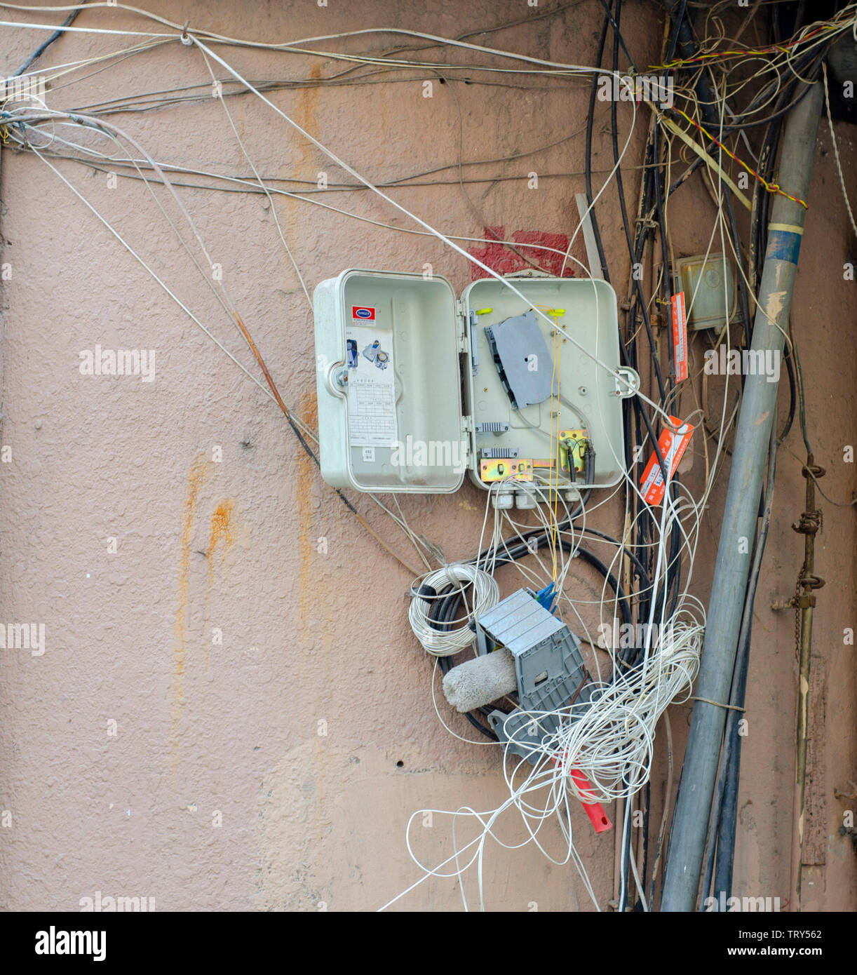 The cluttered wires on the walls have a huge safety hazard Stock Photo ...