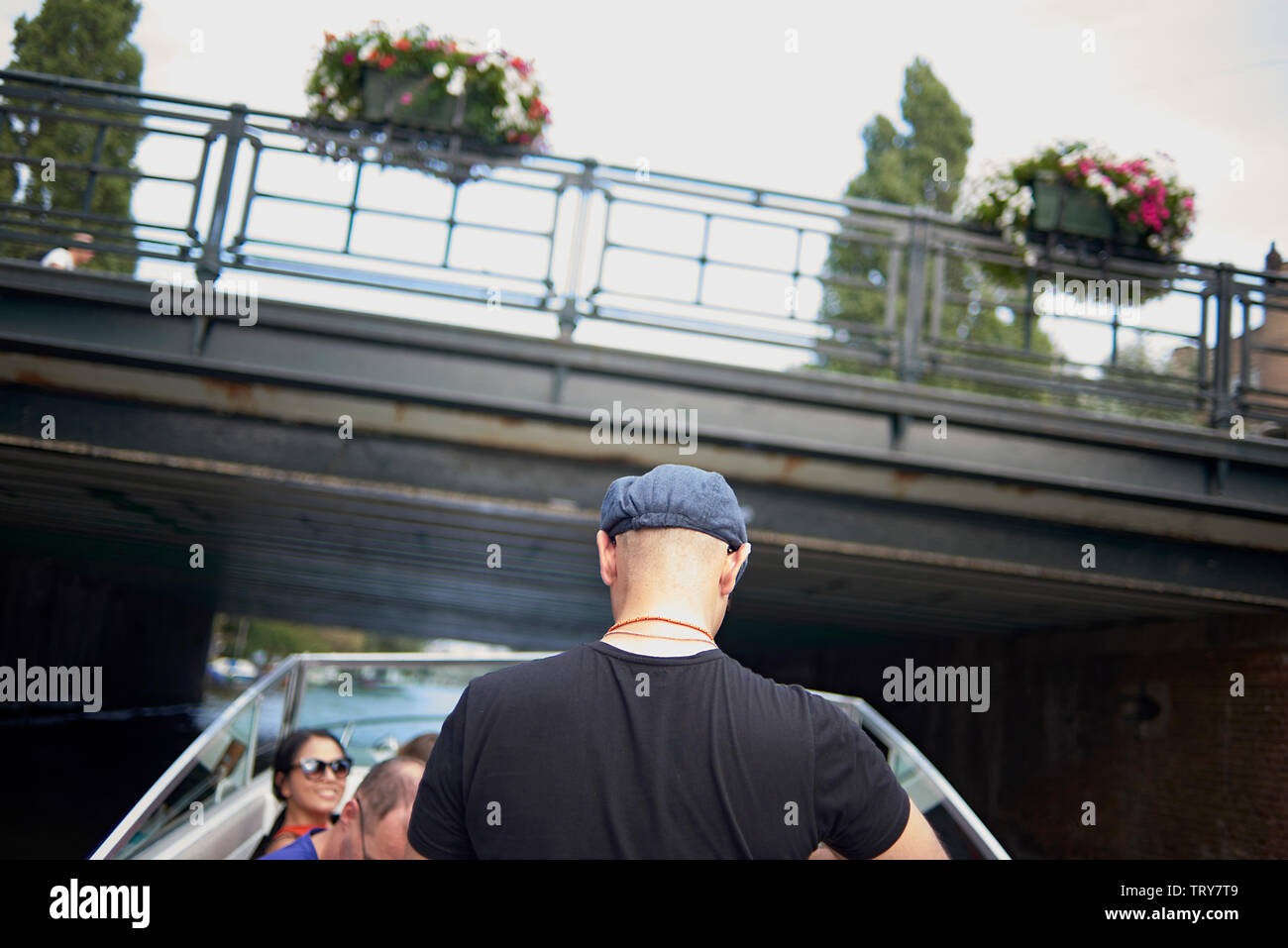 Close up of a Greek man who is captain on a boat in the canals in the ...