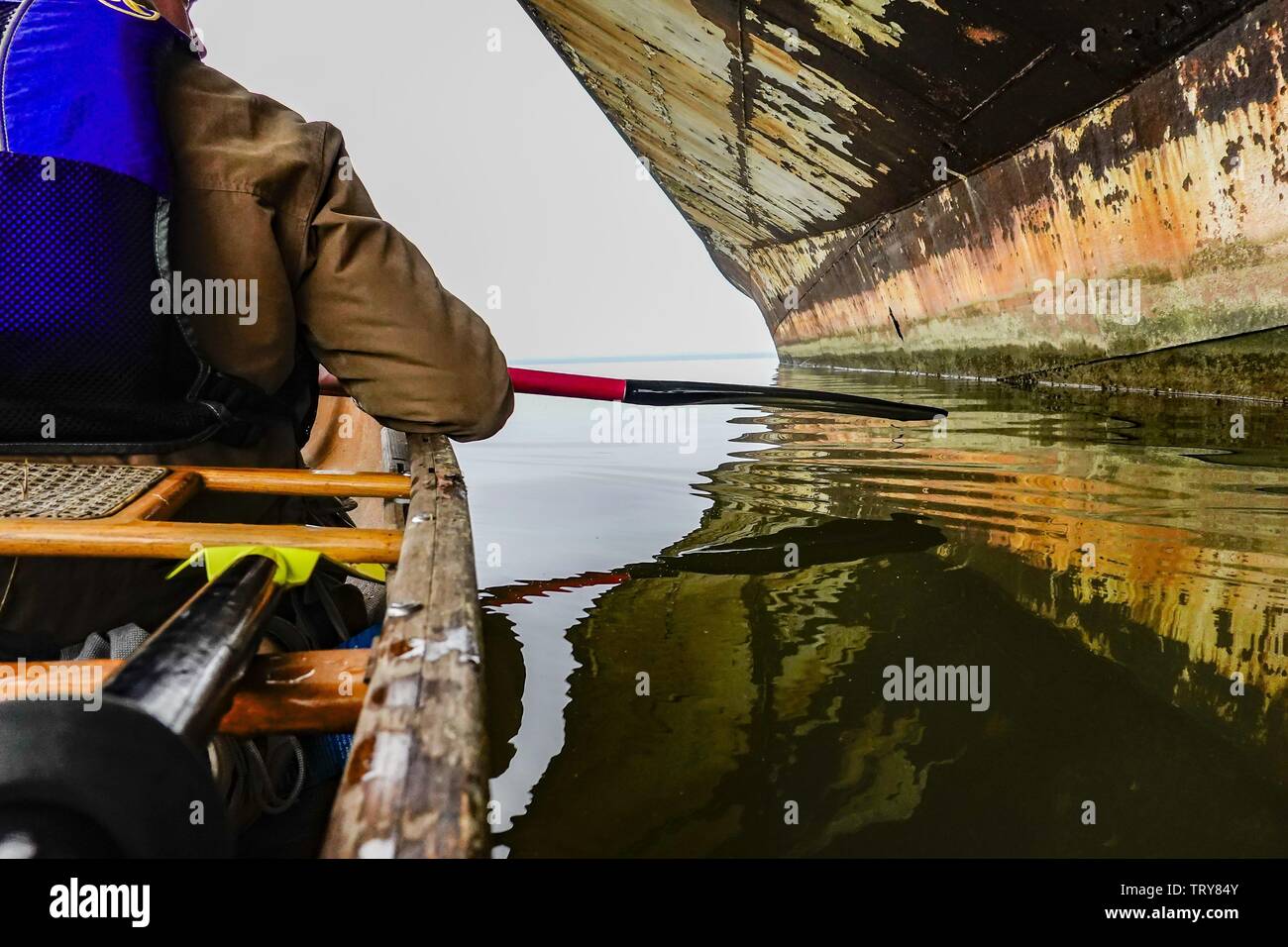 Mallows Bay, Maryland USA A young man canoeing through the ghost fleet ...