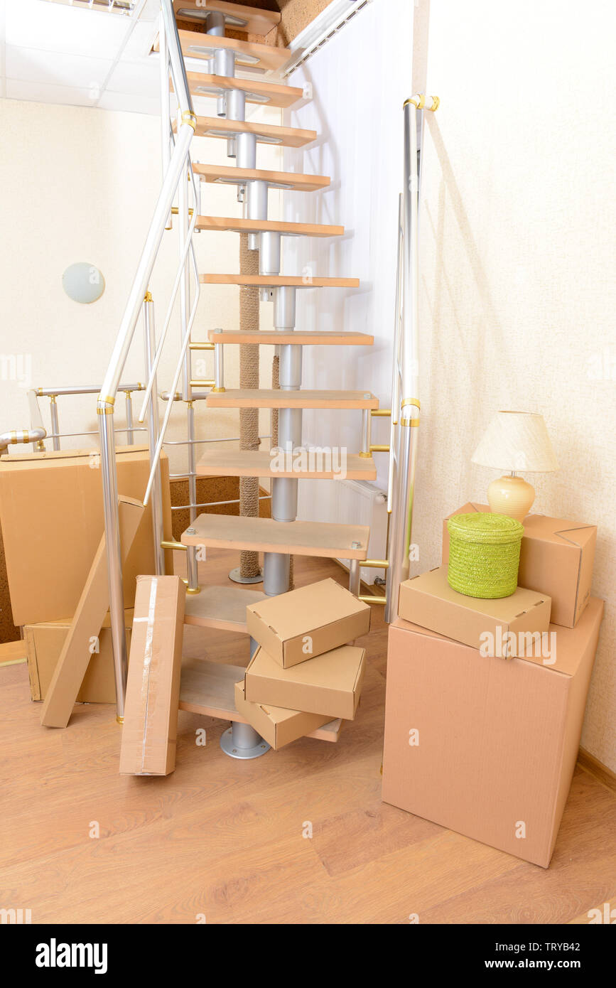 Stack of cartons near stairs: moving house concept Stock Photo - Alamy
