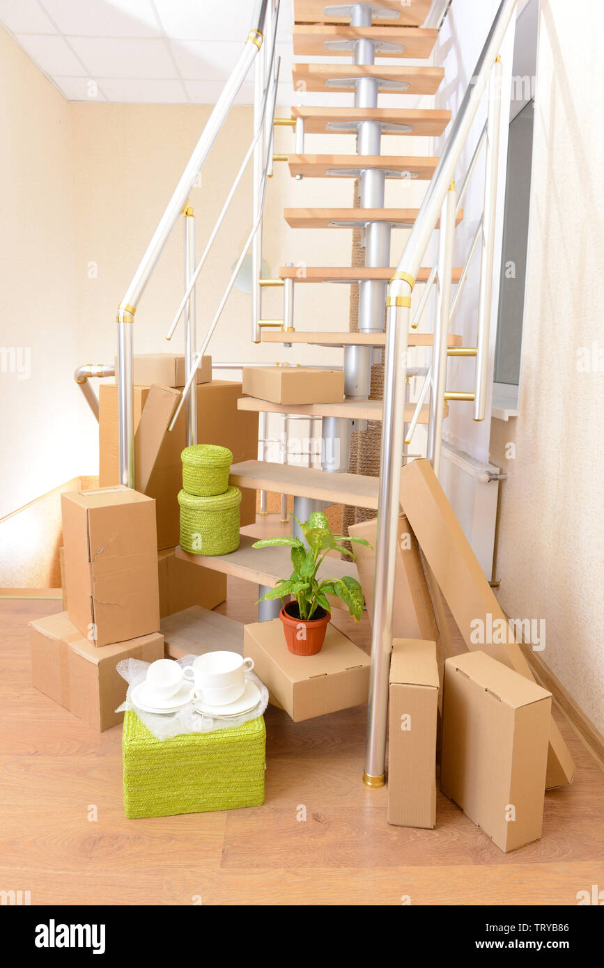 Stack of cartons near stairs: moving house concept Stock Photo - Alamy