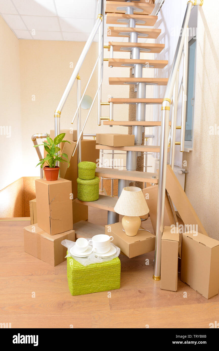 Stack of cartons near stairs: moving house concept Stock Photo - Alamy