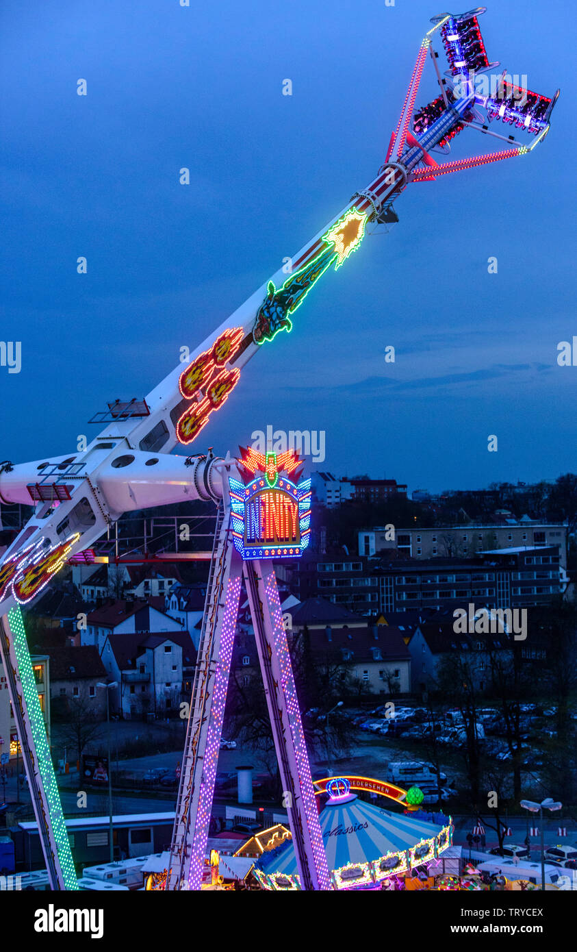 Colorful illuminated fairground attraction - huge vertical carousel ...