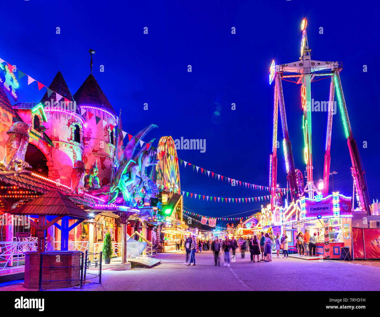 Colorful illuminated fairground attractions on funfair in Augsburg ...