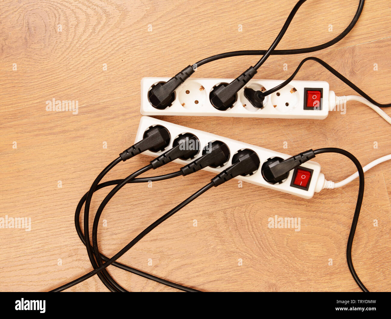 Overloaded power boards, on wooden floor background Stock Photo - Alamy
