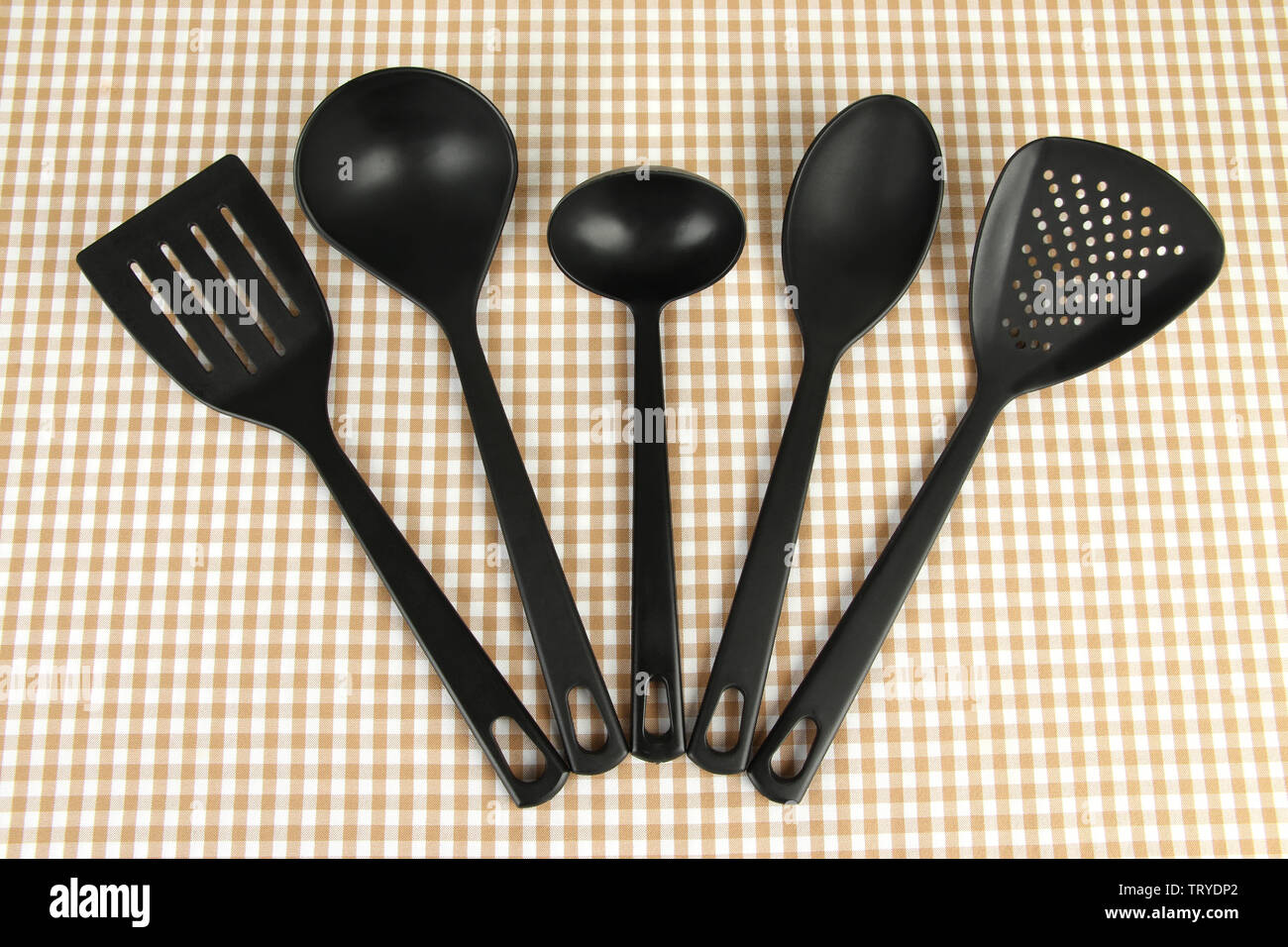 Plastic kitchen utensils on fabric background Stock Photo - Alamy