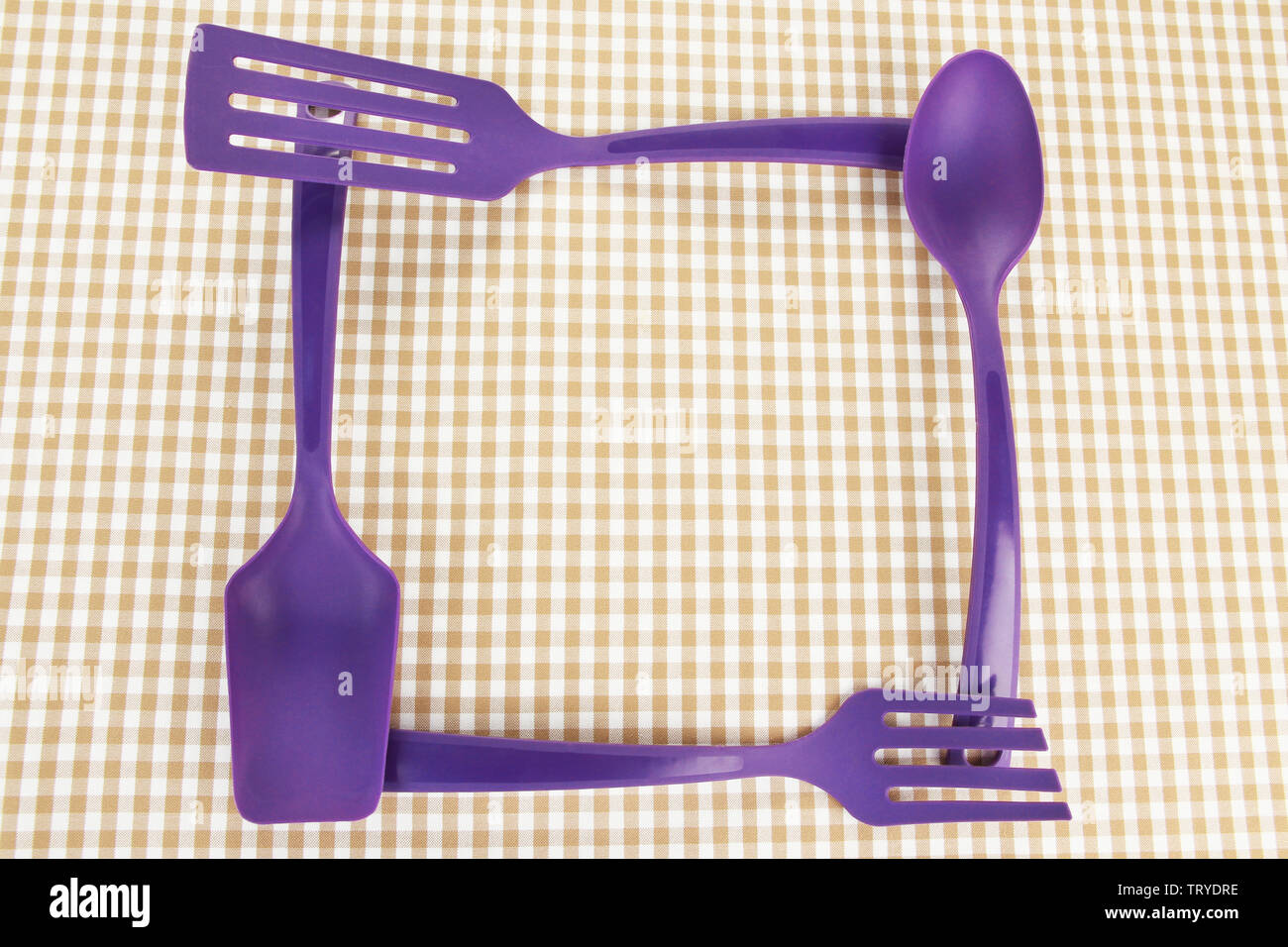 Plastic kitchen utensils on fabric background Stock Photo - Alamy