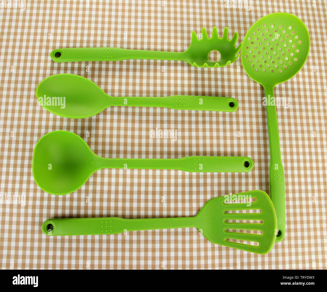Plastic kitchen utensils on fabric background Stock Photo - Alamy